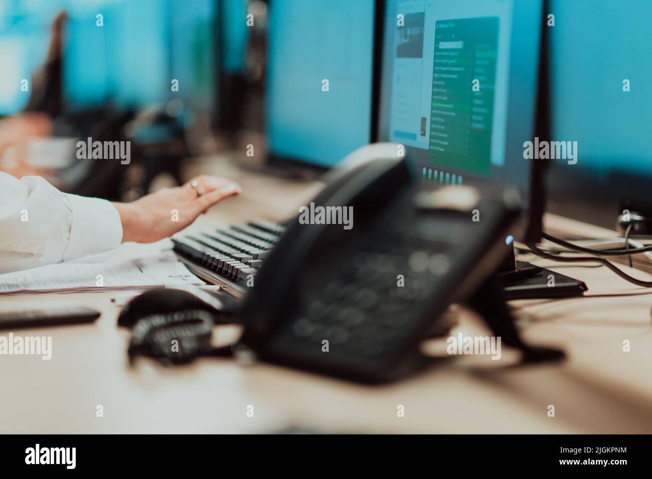 Female security operator working in a data system control room offices ...