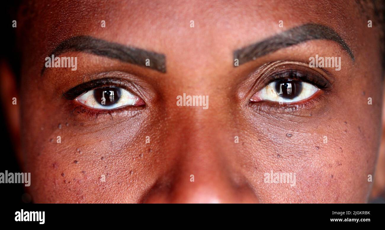 African female eyes staring camera, macro close-up woman eye black ...