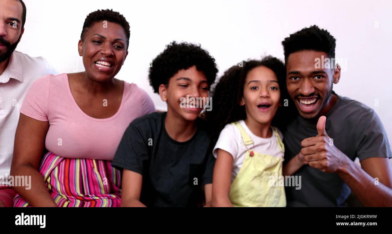 Black African family waving hello to camera, parent and kids talking to ...