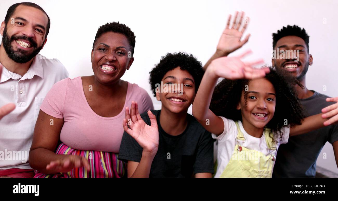 Black African family waving hello to camera, parent and kids talking to ...