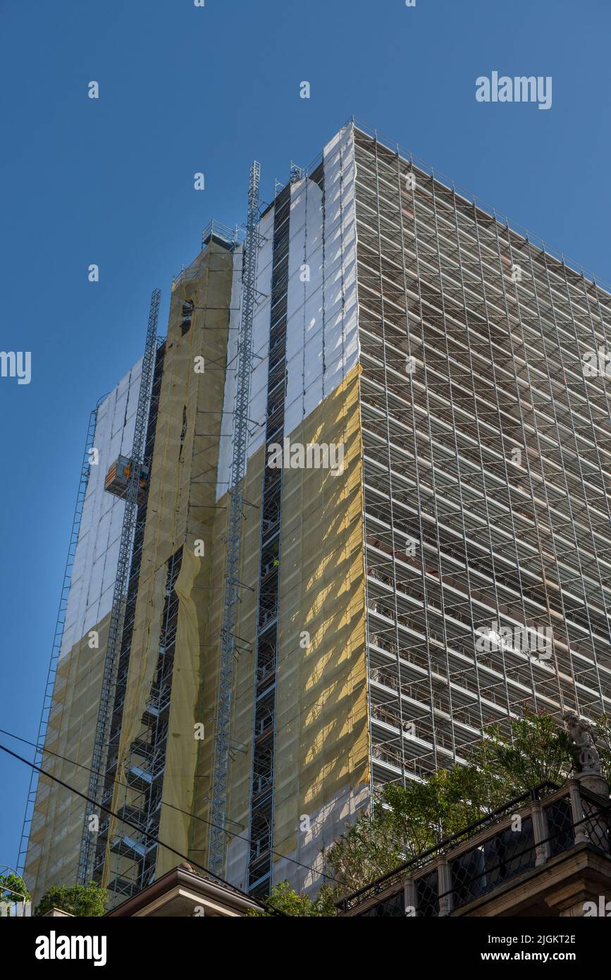 Building with scaffolding and protective Stock Photo - Alamy