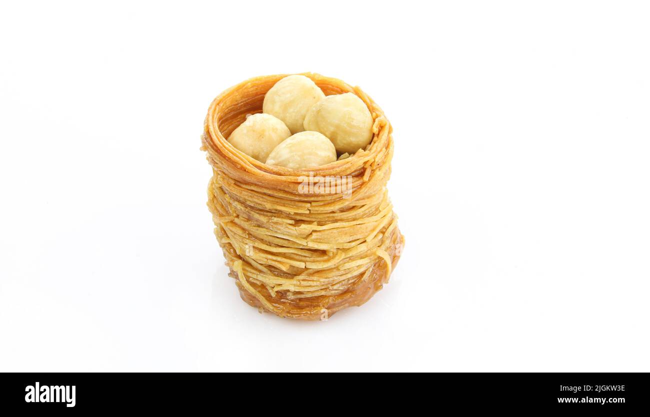 Hazelnuts in kadayif shaped like bird nest. Turkish delicacy isolated ...