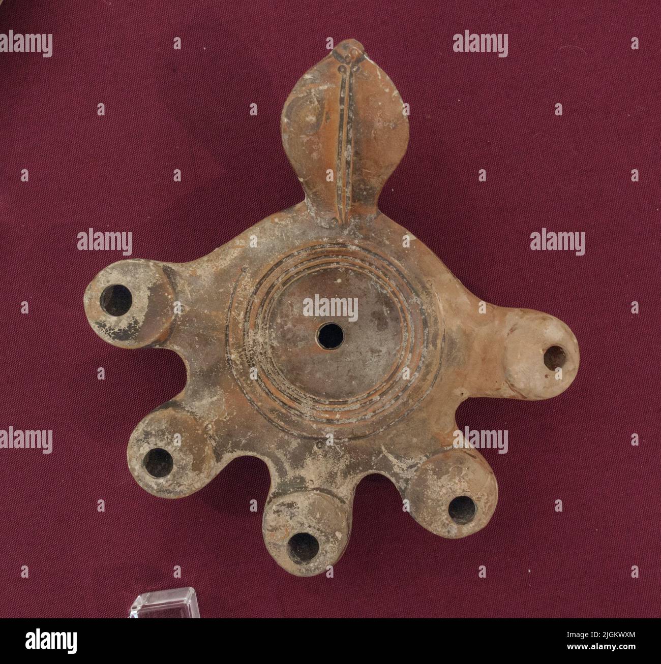 A Roman lamp (c. 300-399AD) bearing the Chi-Ro symbol on display in a ...