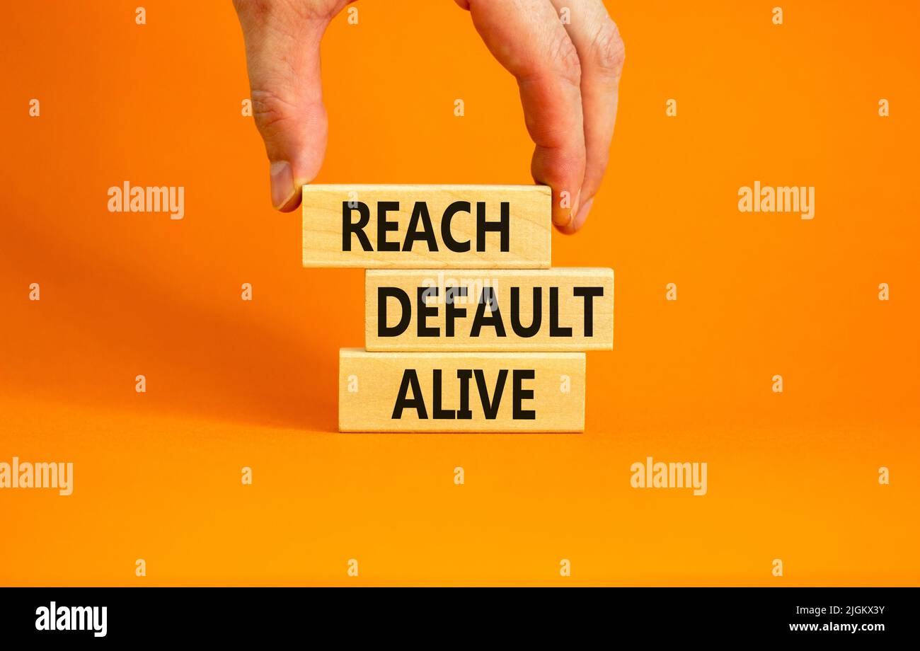 Reach default alive symbol. Concept words Reach default alive on wooden ...