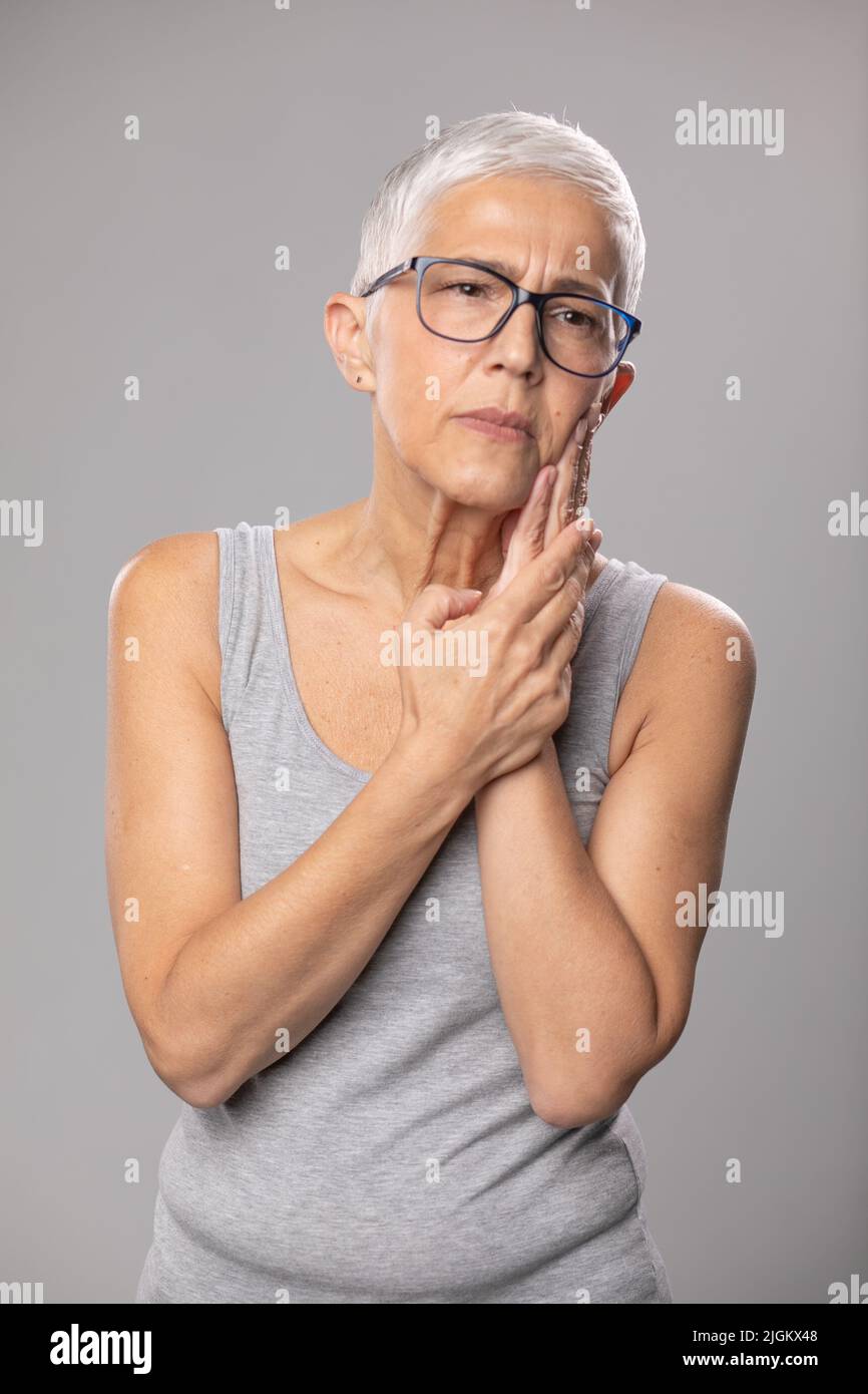 Toothache. pain tooth in mouth, old woman with short gray hair and ...