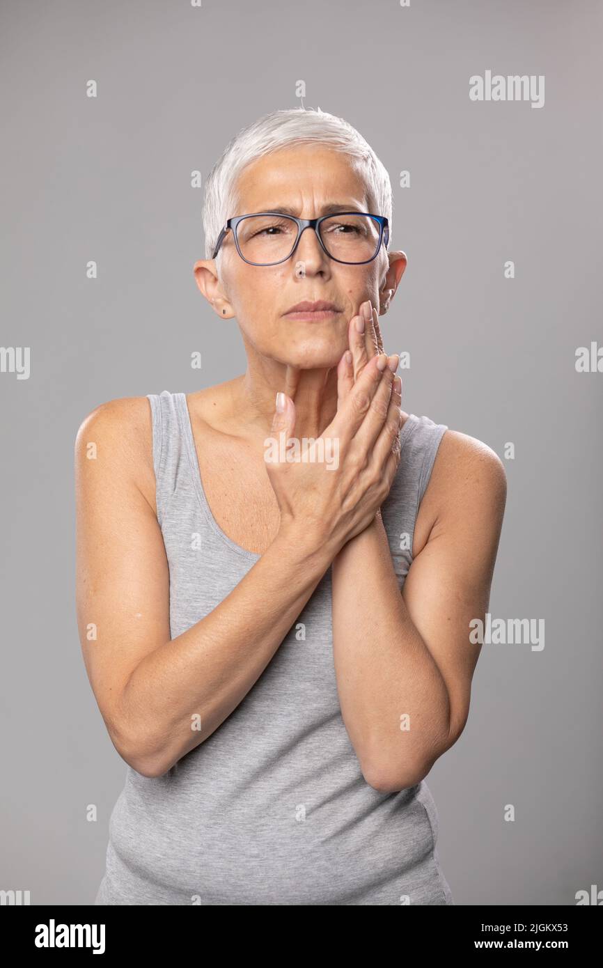 Toothache. pain tooth in mouth, old woman with short gray hair and ...