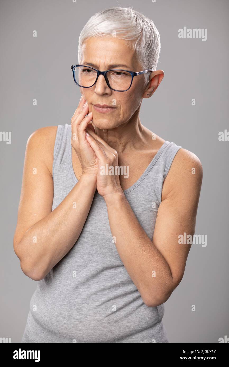 Toothache. pain tooth in mouth, old woman with short gray hair and ...