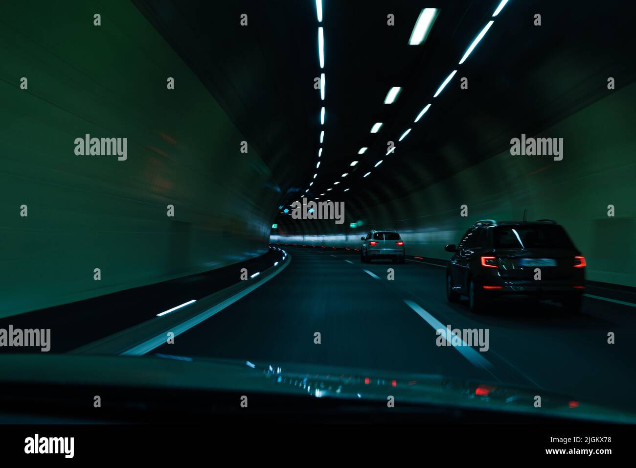 Cars driving fast through modern European tunnel. Switzerland Stock ...