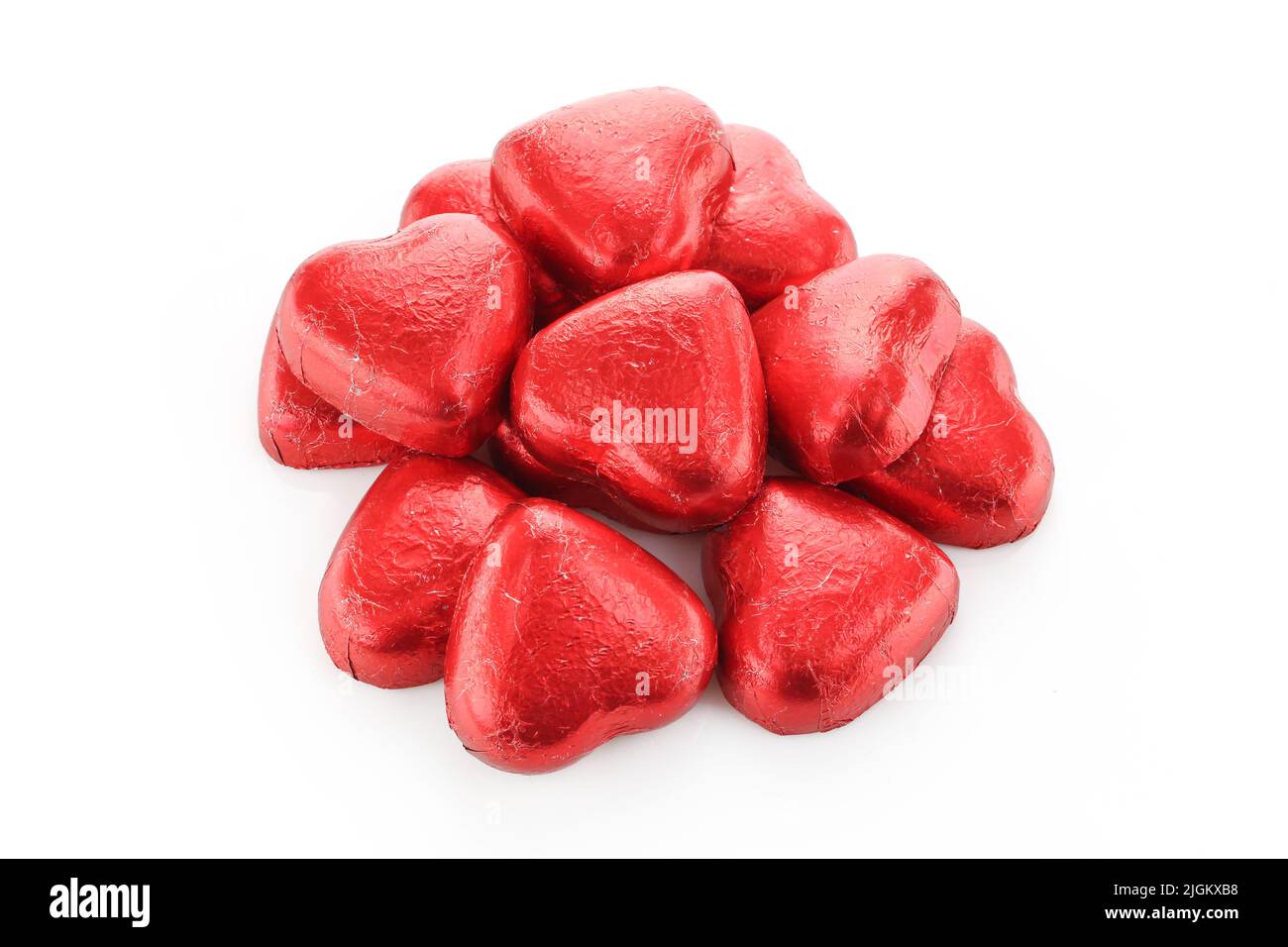 Group of heart shaped chocolate candies wrapped in red foil isolated on ...