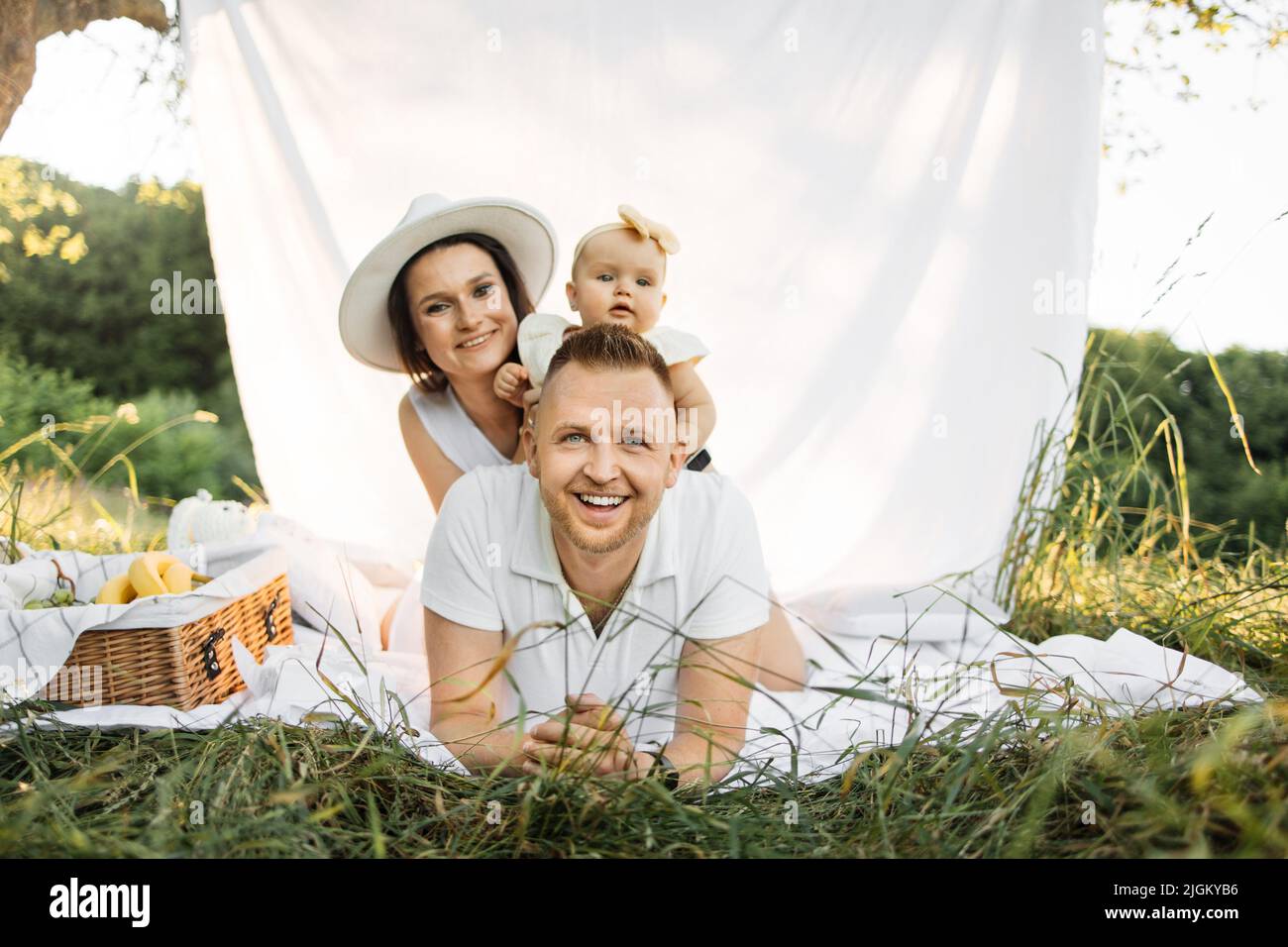 Beautiful caucasian family of father, mother and little daughter posing ...