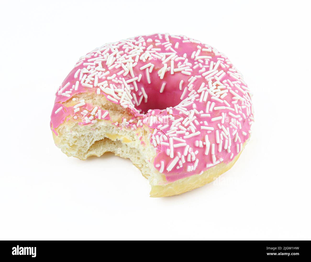Bitten pink donut with sprinkles icing isolated on white background ...