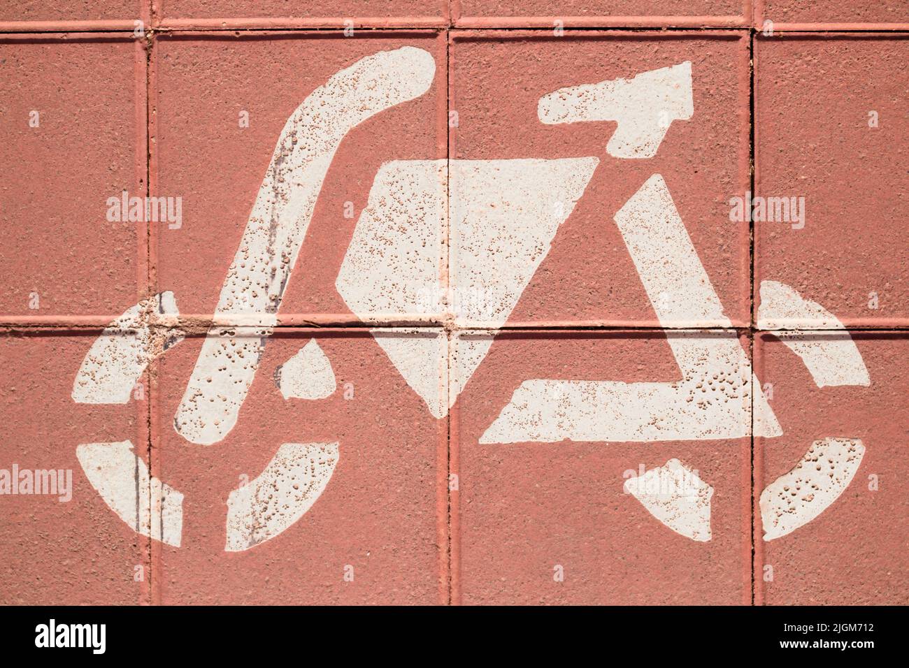 Closeup of a painted sign on the ground of a white painted bicycle on ...