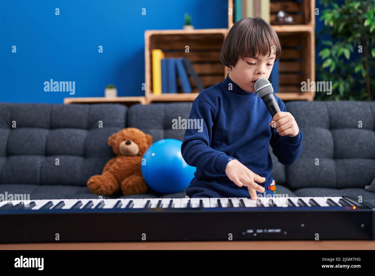 Child playing instrument down syndrome hi-res stock photography and ...
