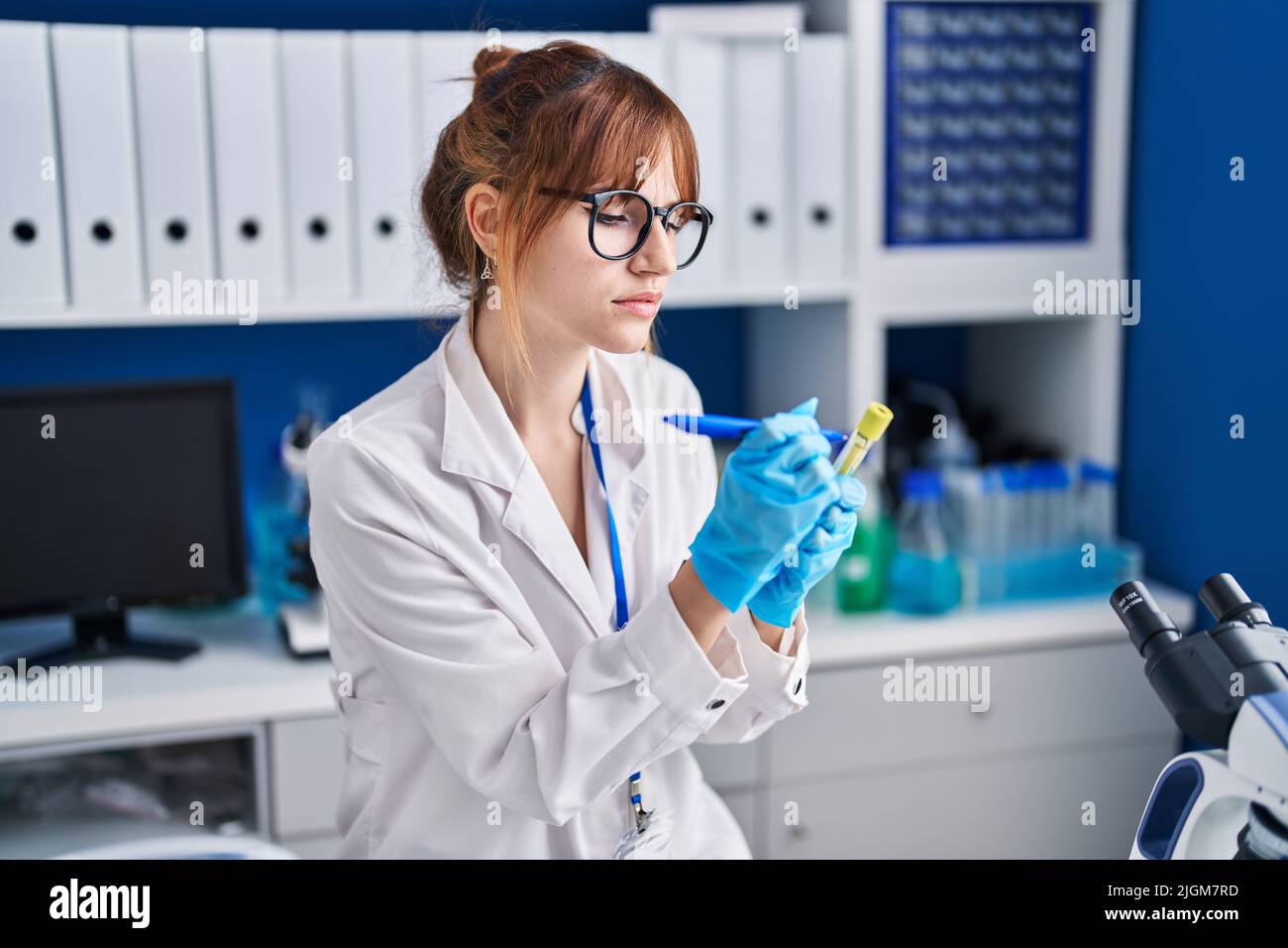 Young woman scientist write on test tube at laboratory Stock Photo - Alamy