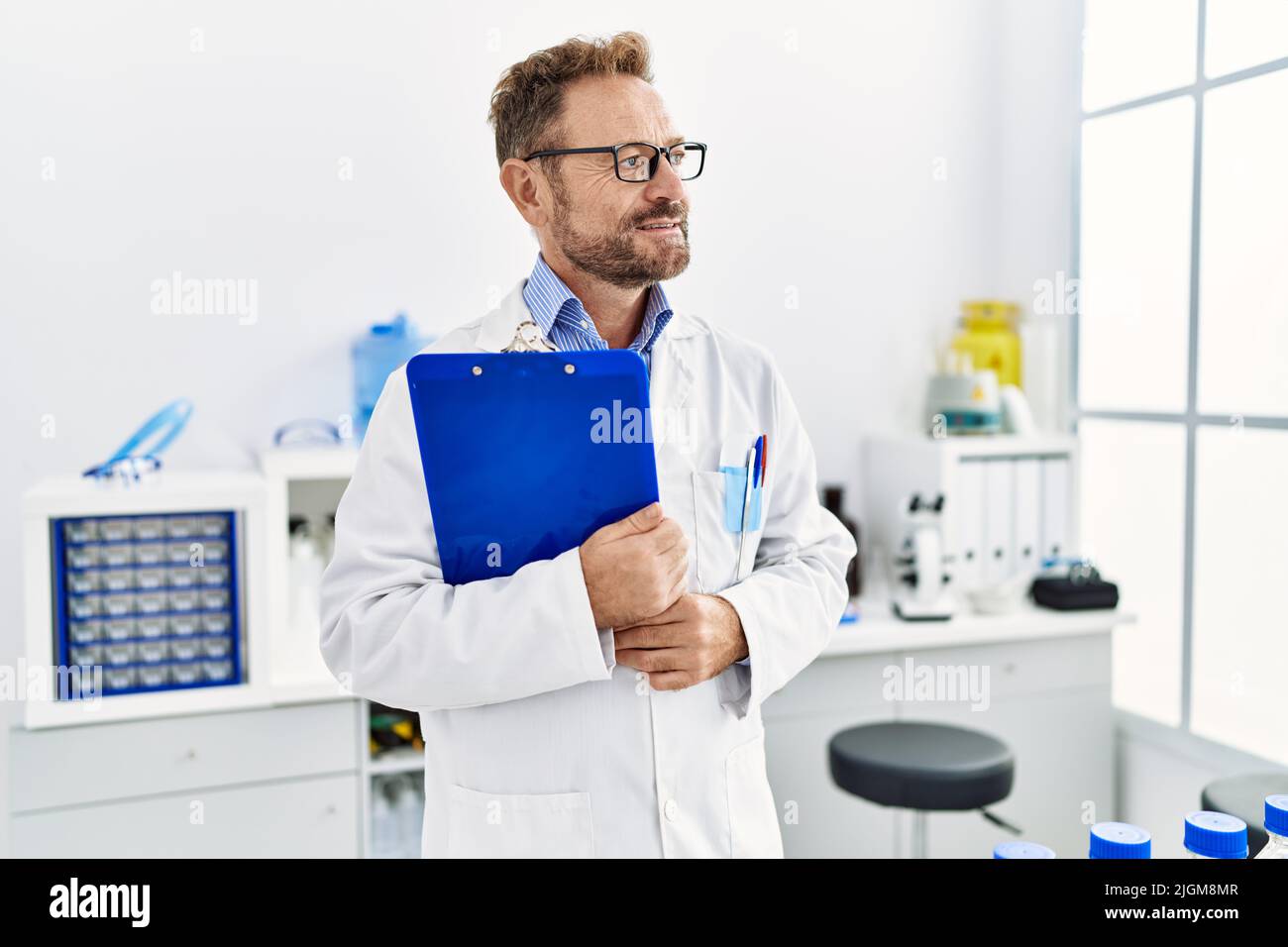 Middle age hispanic man smiling confident wearing scientist uniform at ...