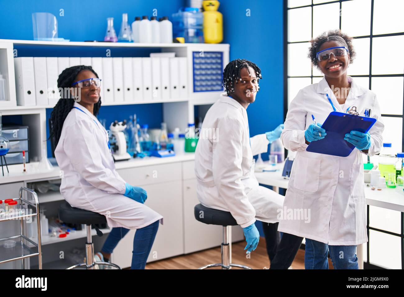 African american friends scientists smiling confident working at ...