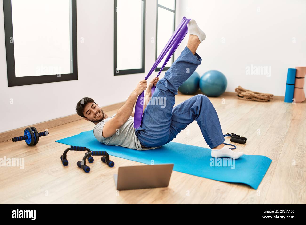 Young hispanic sporty man smiling happy having online sport class at ...