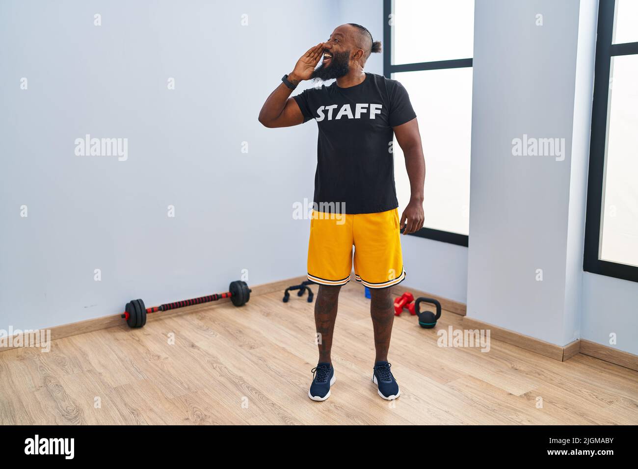 African american man working at fitness gym clueless and confused with ...