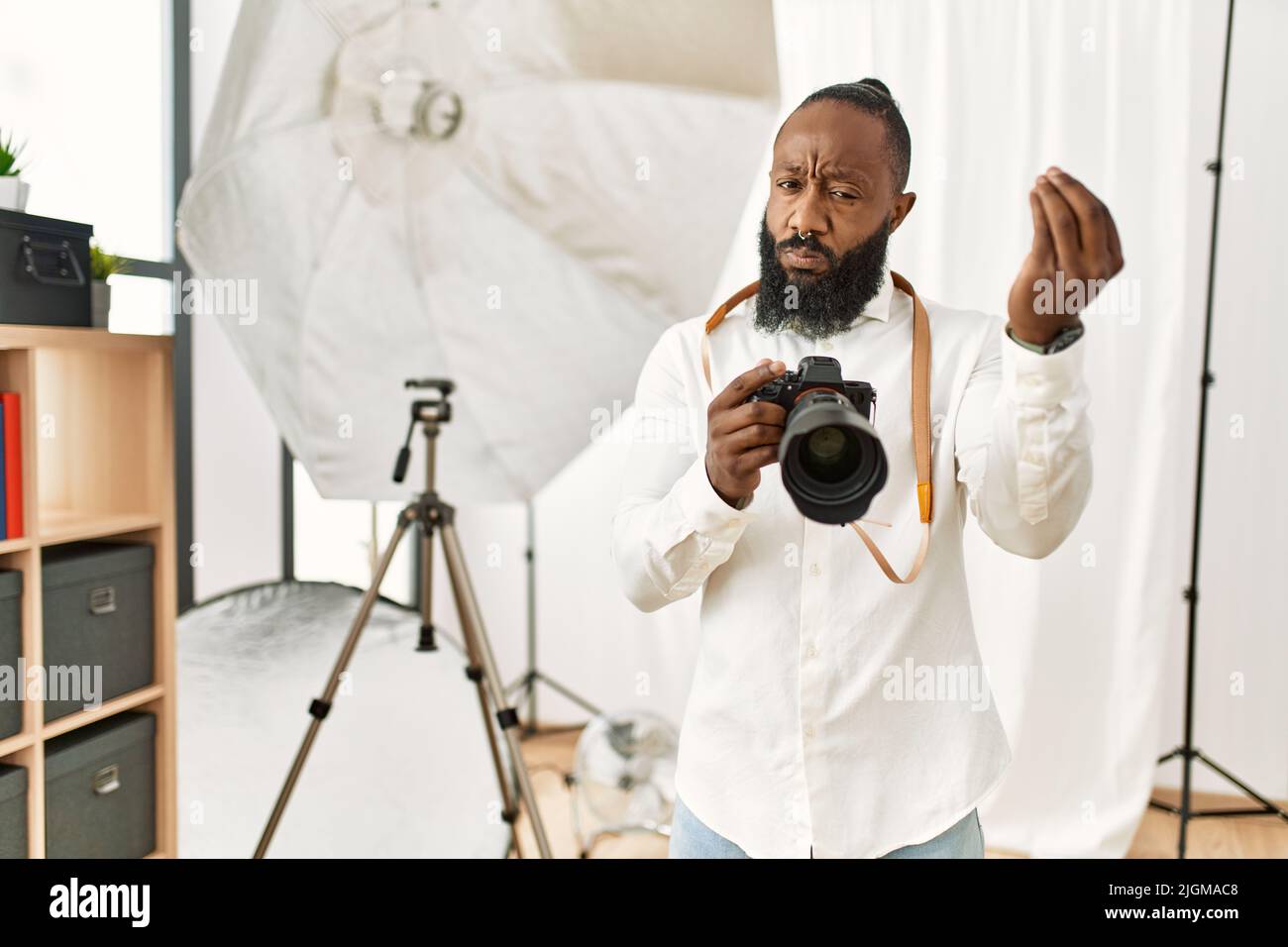 African american photographer man working at photography studio doing ...
