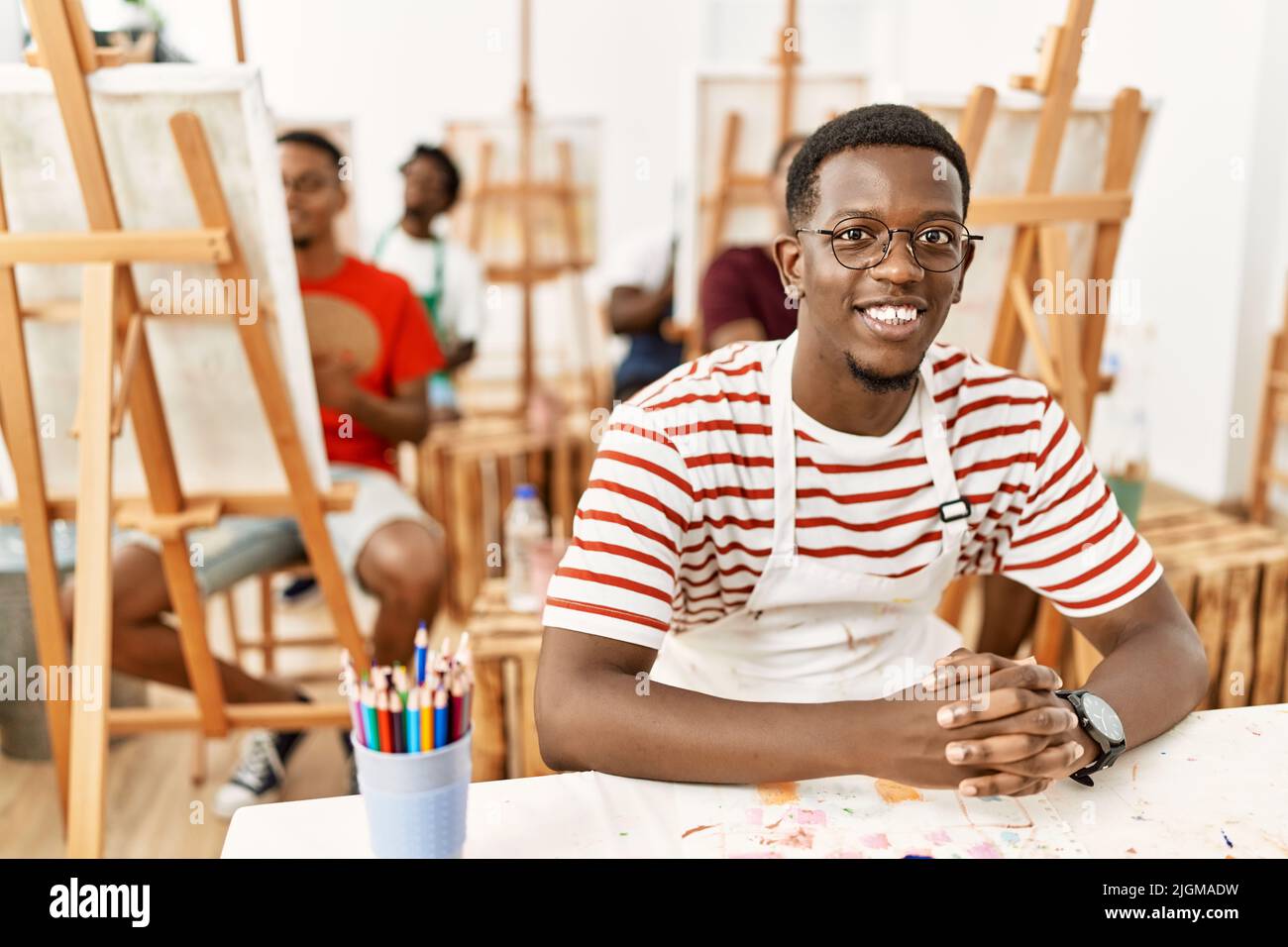 Group of young african american artist students drawing at art studio ...