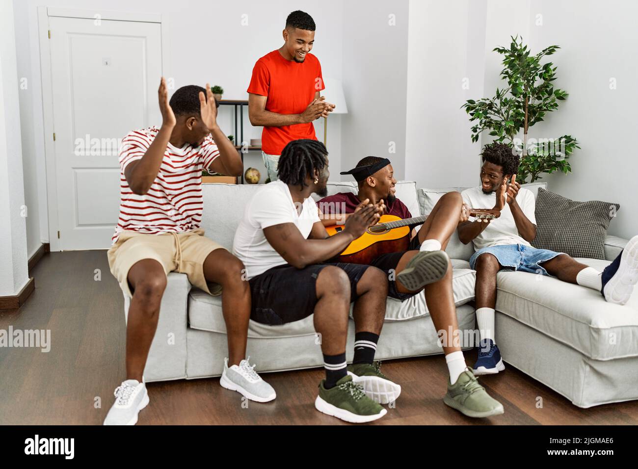 Group of african american people having party playing classical guitar ...