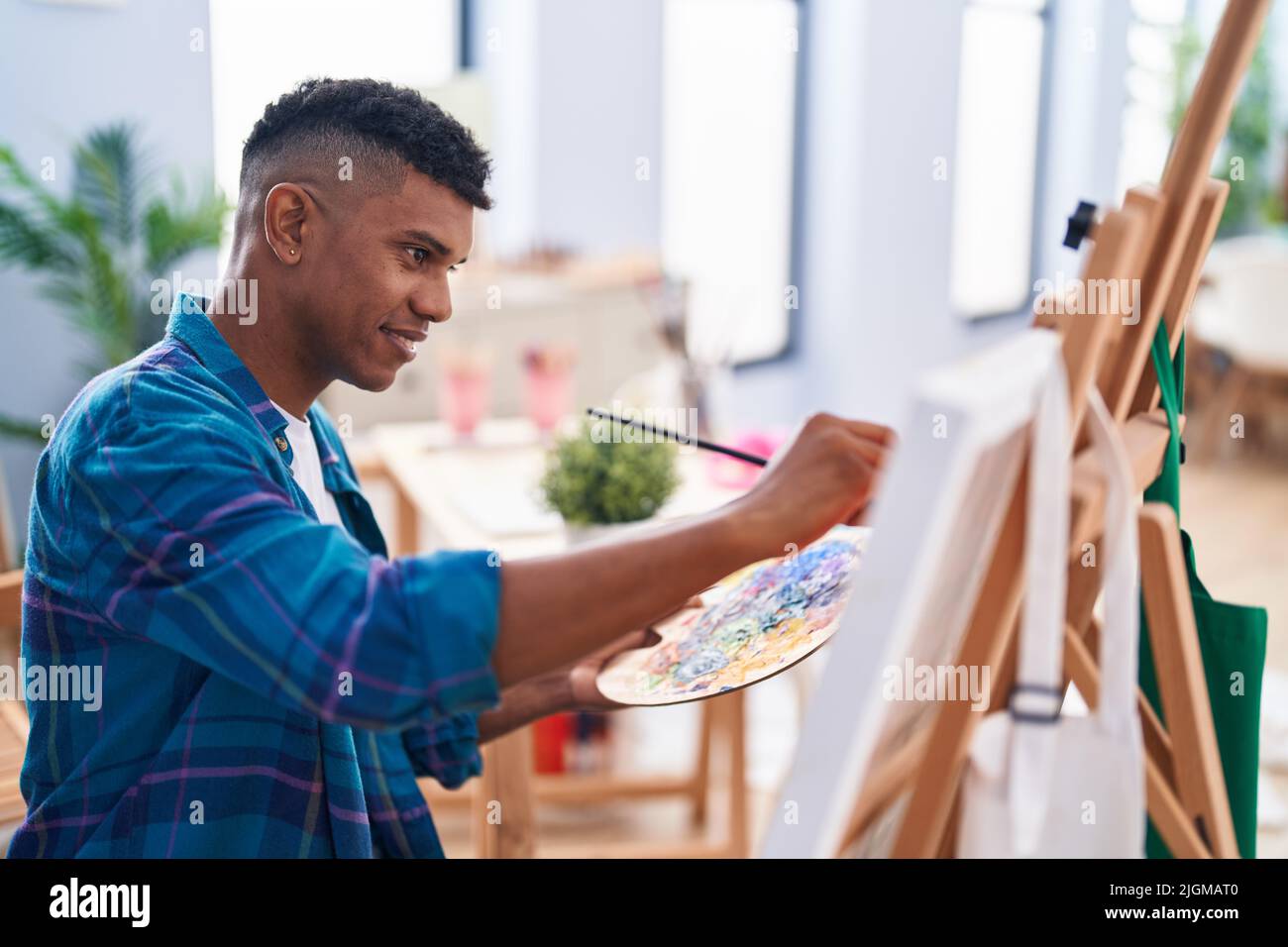 Young latin man artist smiling confident drawing at art studio Stock ...
