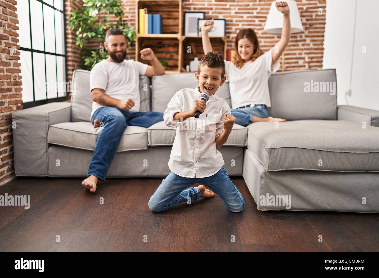 Family singing song using microphone at home Stock Photo - Alamy