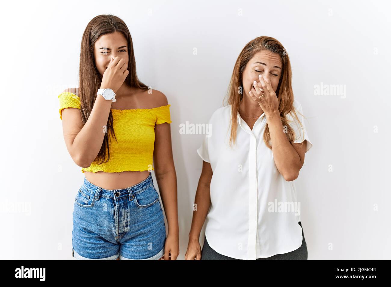 Mother and daughter together standing together over isolated background ...