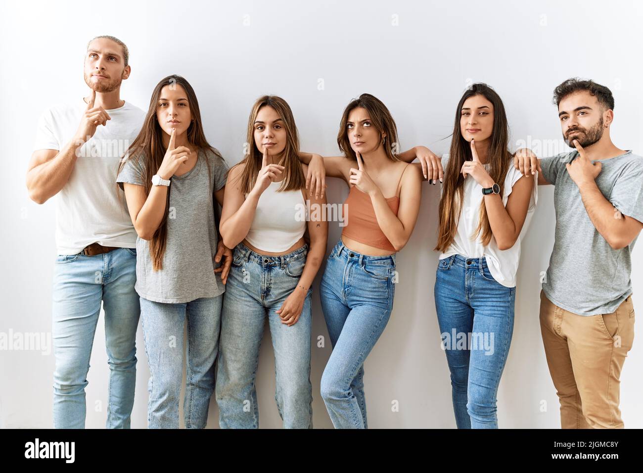 Group of young friends standing together over isolated background ...