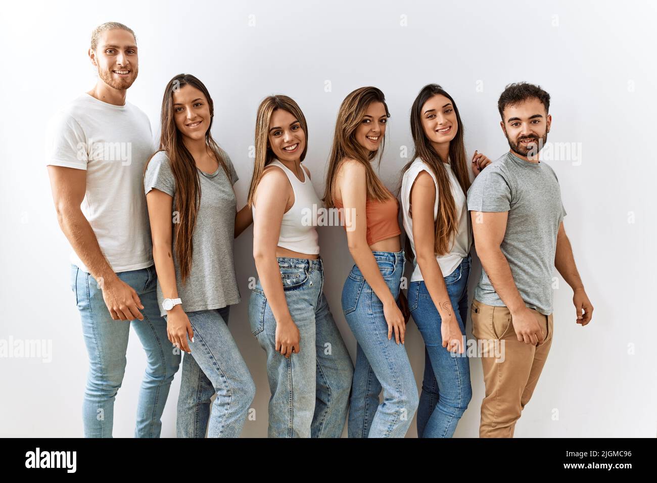Group of young friends standing together over isolated background ...
