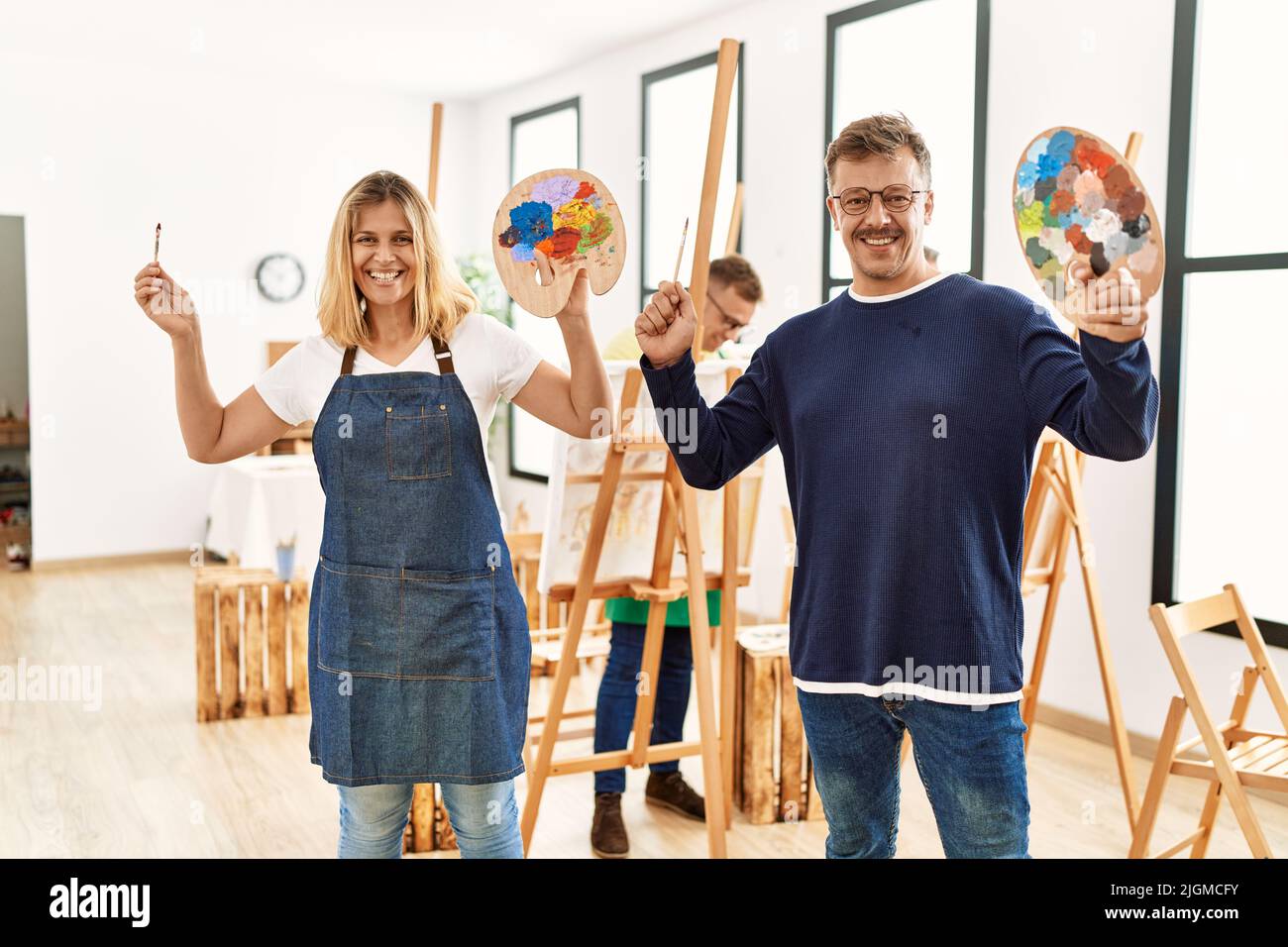 Group of middle age people drawing at art studio. Two students smiling ...