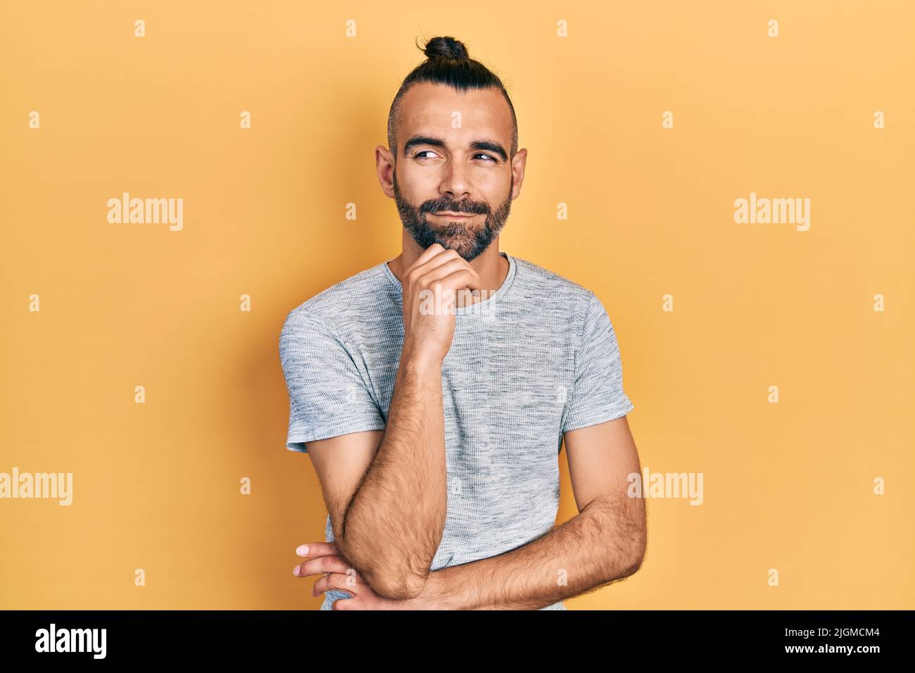 Young hispanic man wearing casual clothes serious face thinking about ...