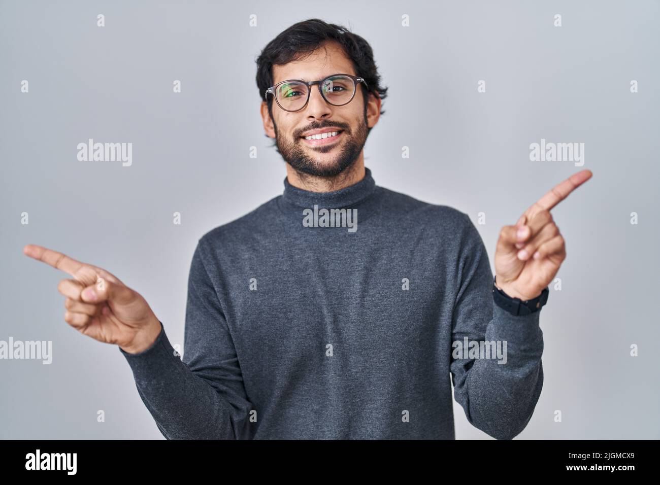 Handsome latin man standing over isolated background smiling confident ...