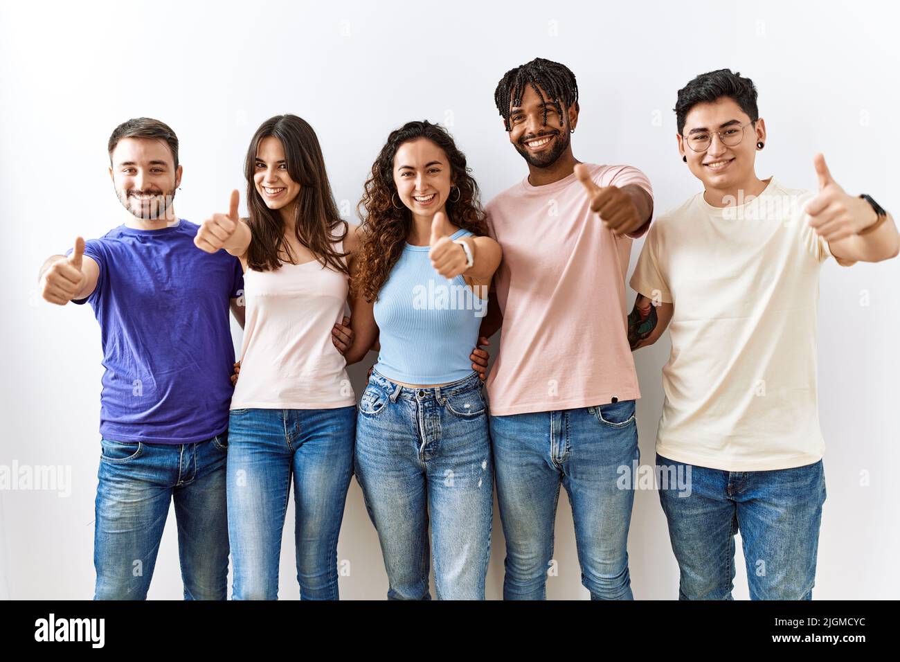Group of young people standing together over isolated background ...