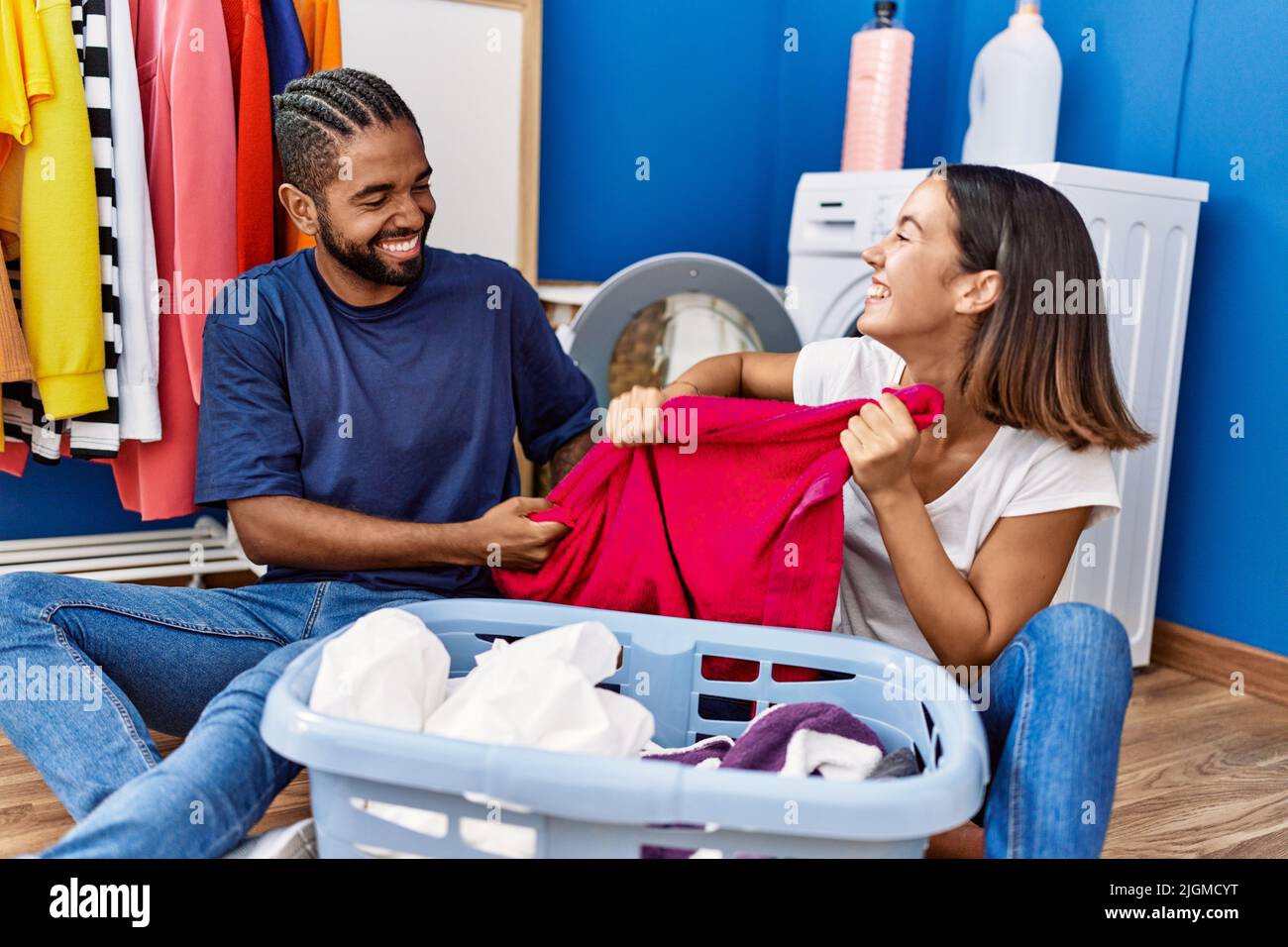 Man and woman couple smiling confident washing clothes at laundry Stock ...
