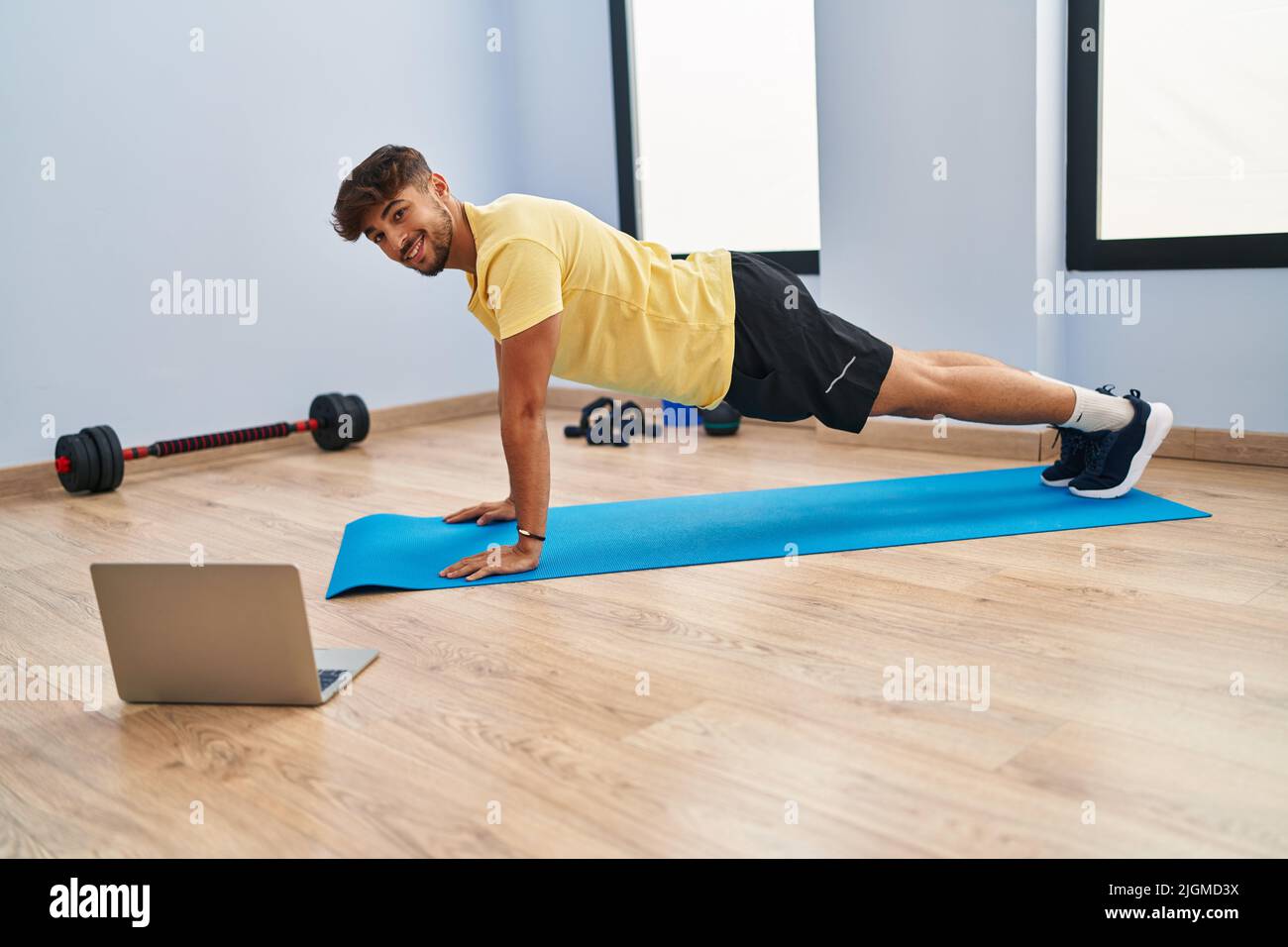 Young arab man smiling confident having online training at sport center ...