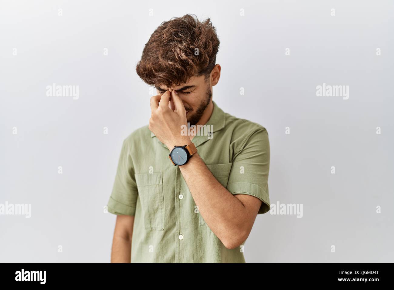 Young arab doctor man standing over isolated background tired rubbing ...