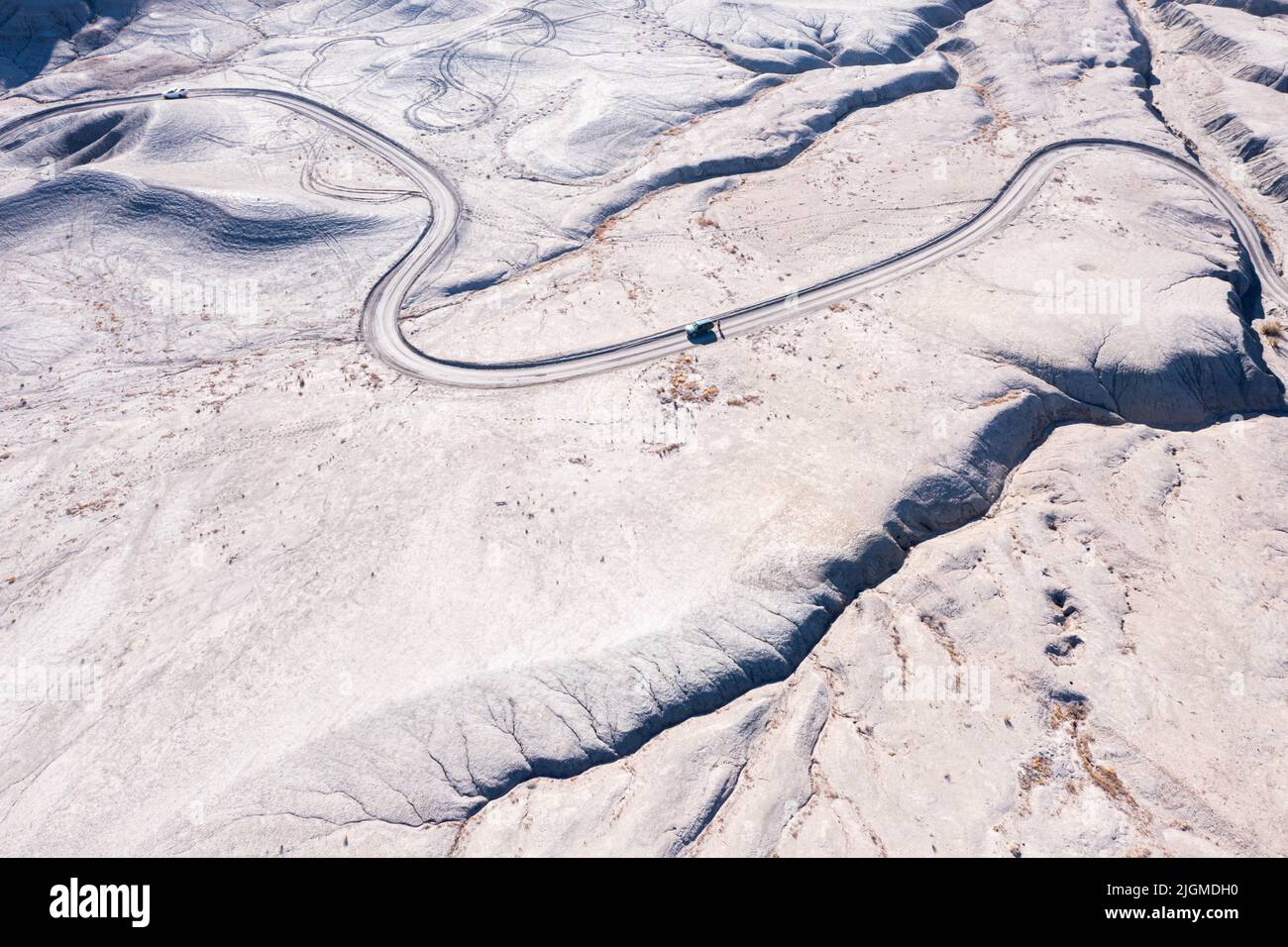 Off roading dirt road in Utah badlands. Vehicle and person on road ...