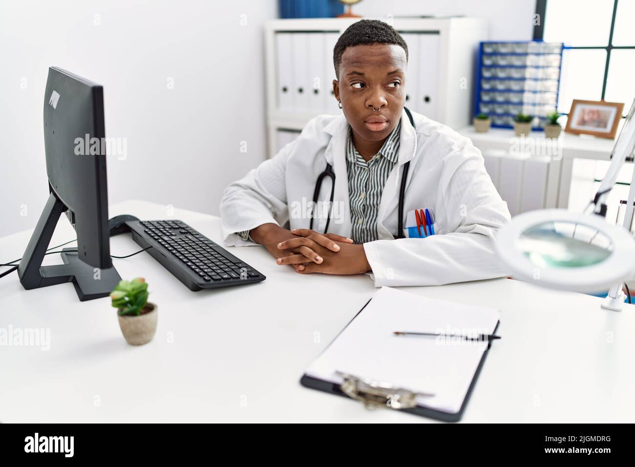 Young african man working as doctor at medical clinic Stock Photo - Alamy