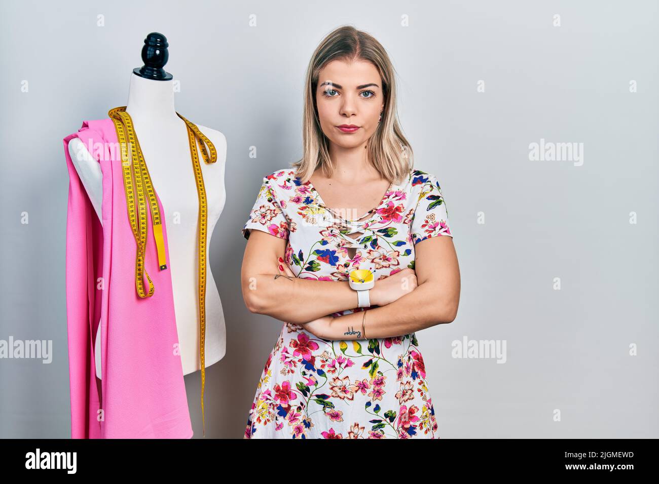 Beautiful caucasian woman dressmaker designer by manikin skeptic and ...