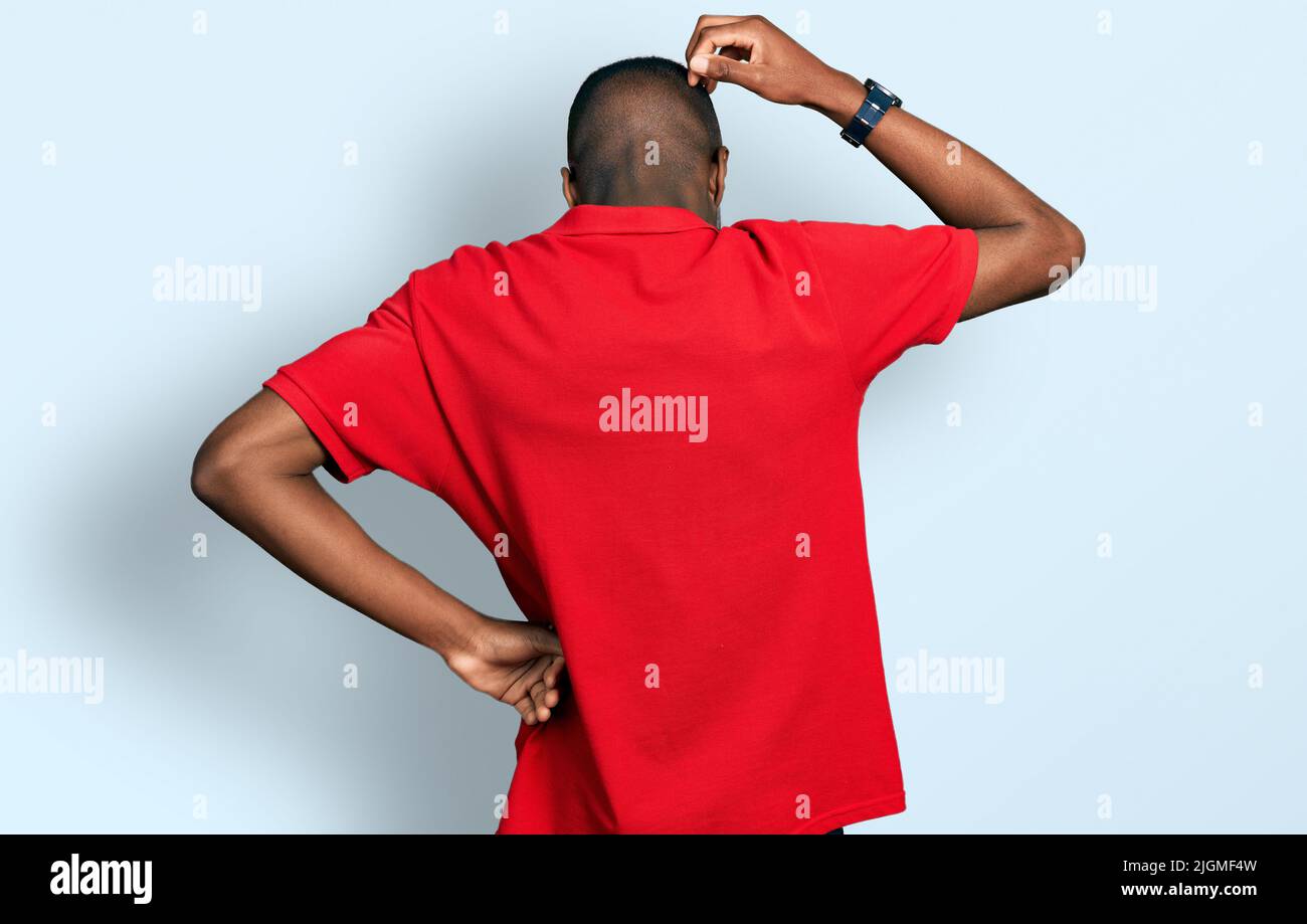 Young african american man wearing casual red t shirt backwards ...