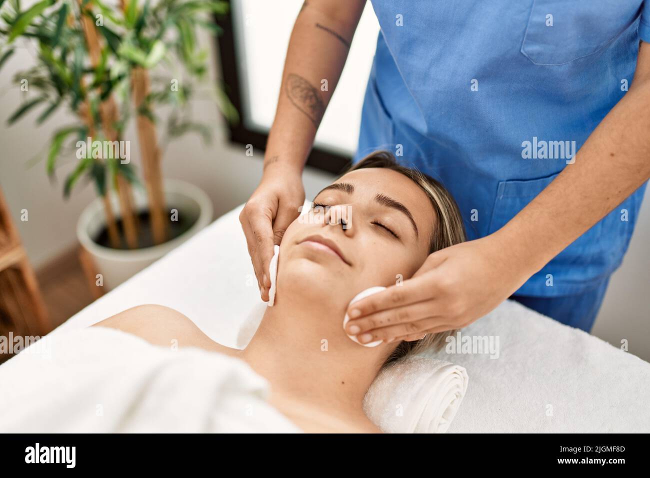 Woman couple having facial treatment cleaning skin face at beauty ...