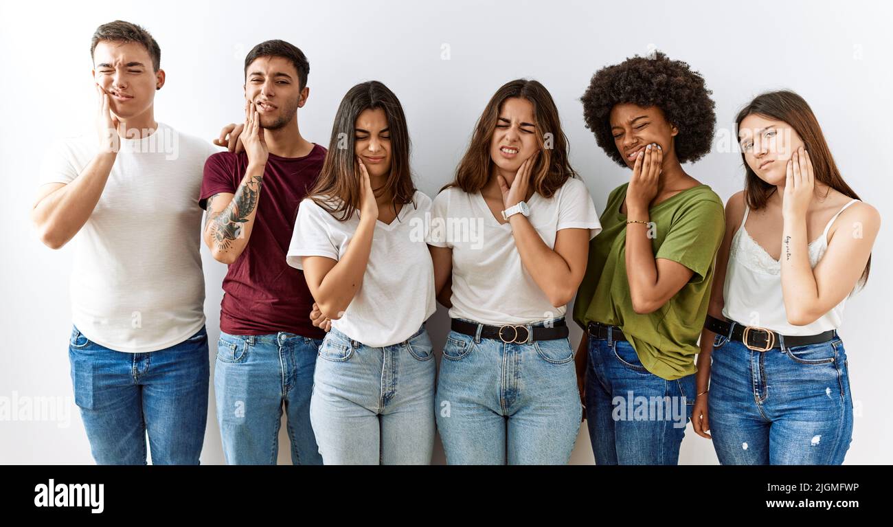 Group of young friends standing together over isolated background ...