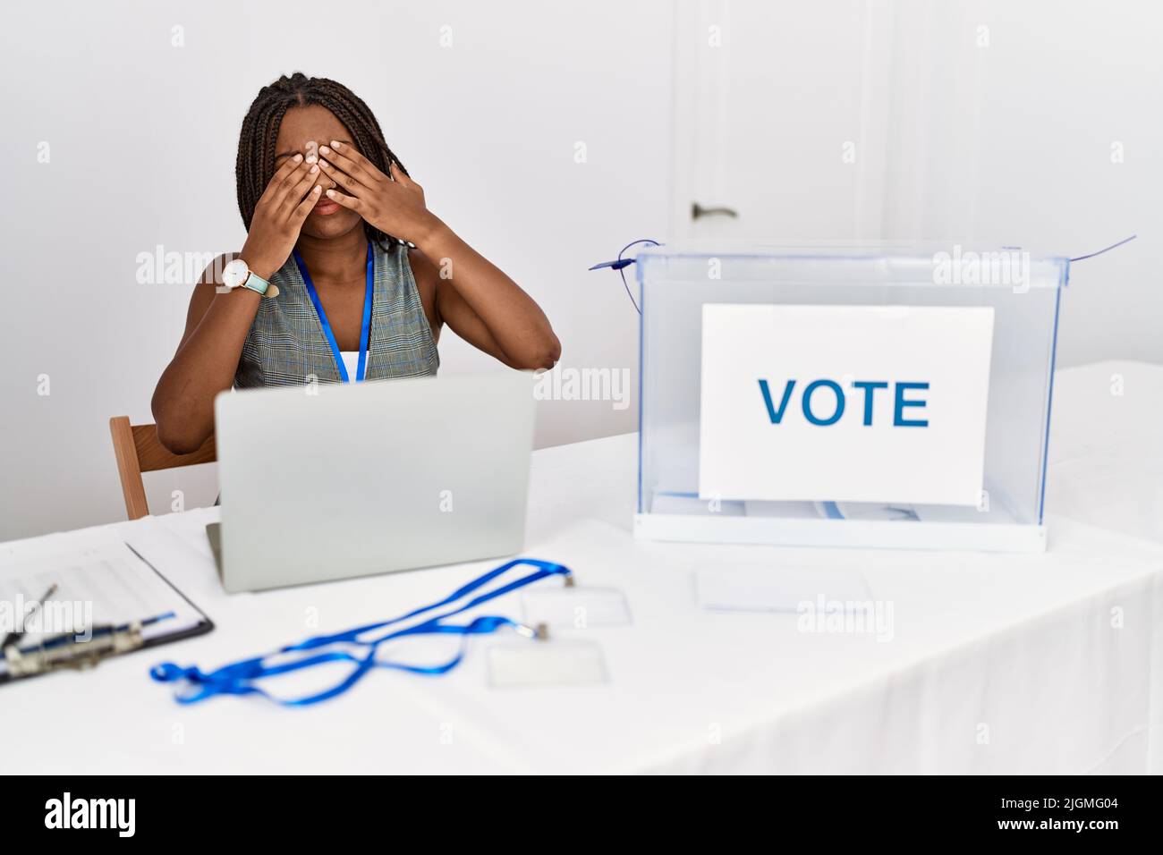 Young african american woman working at political election sitting by ...