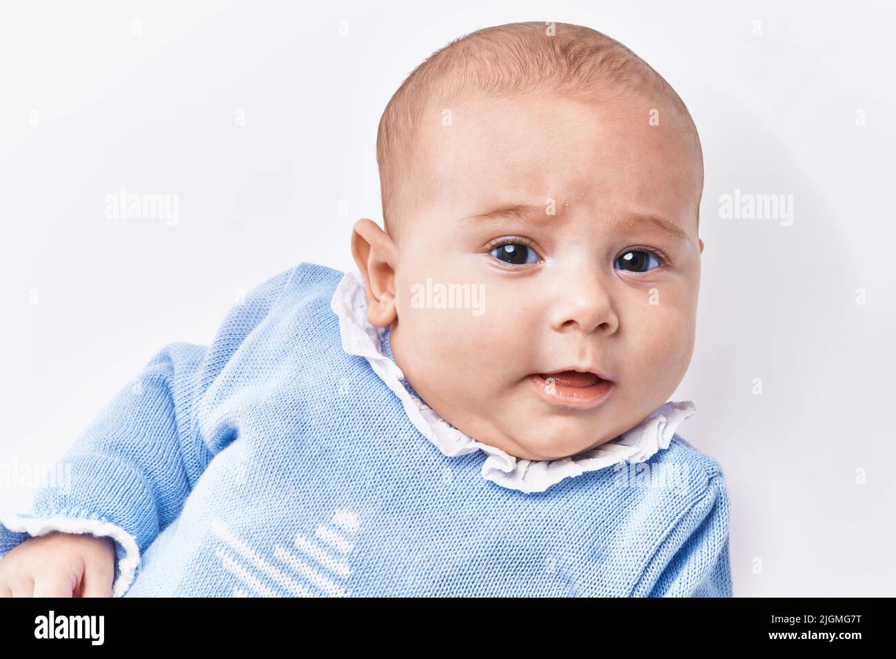 Adorable baby relaxed over white isolated background Stock Photo - Alamy