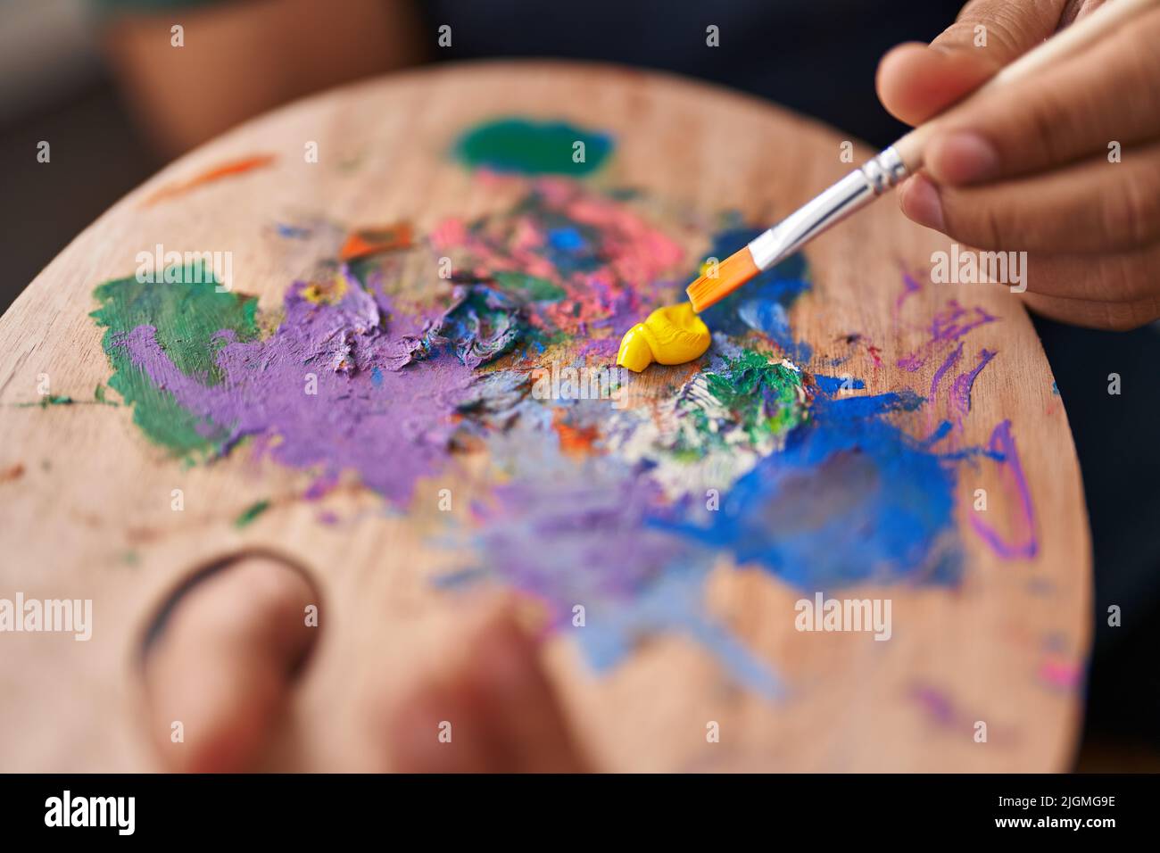 African american man artist mixing color on palette at art studio Stock ...