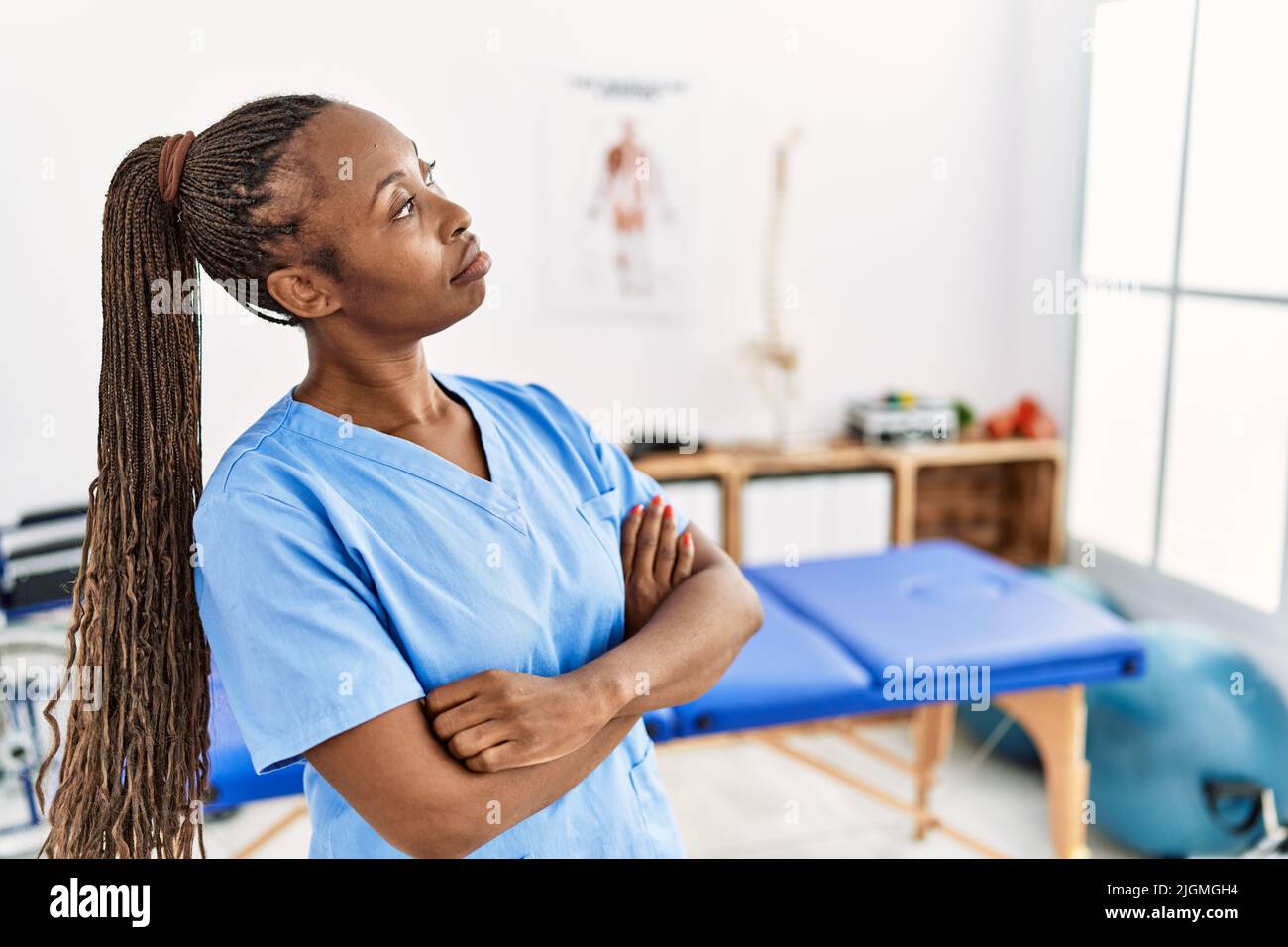 Black woman with braids working at pain recovery clinic looking to the ...