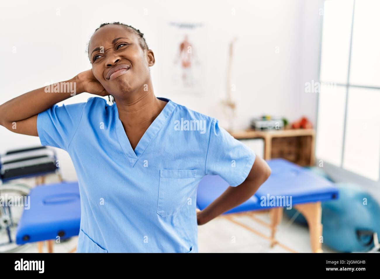 Black woman with braids working at pain recovery clinic suffering of ...
