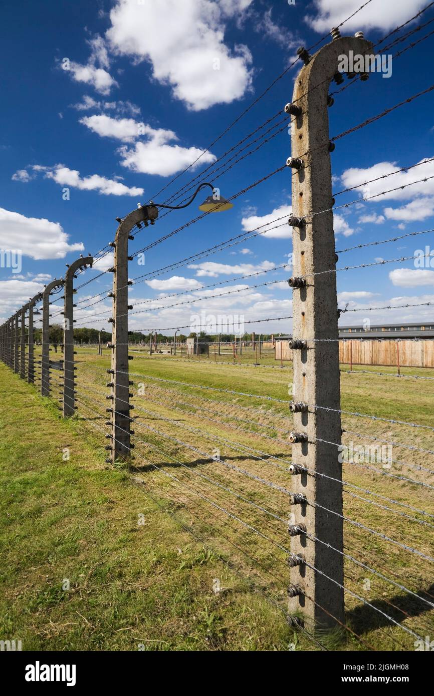 Barbed wire electric fence surrounding the Auschwitz II-Birkenau former ... Barbed wire electric fence surrounding the Auschwitz II-Birkenau former ...