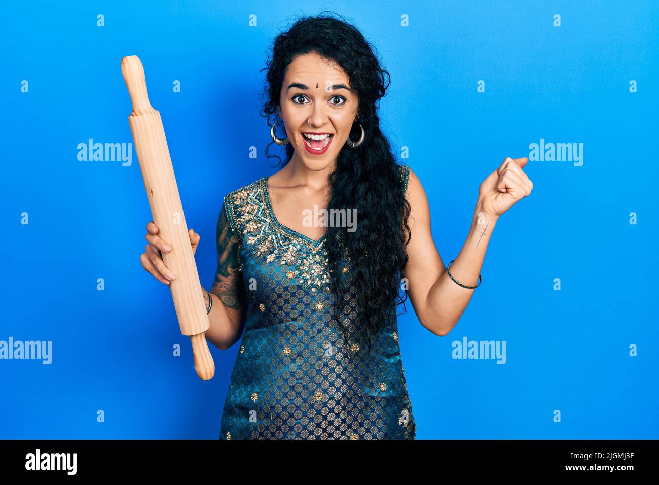 Young woman wearing bindi and traditional kurta dress holding kneading ...